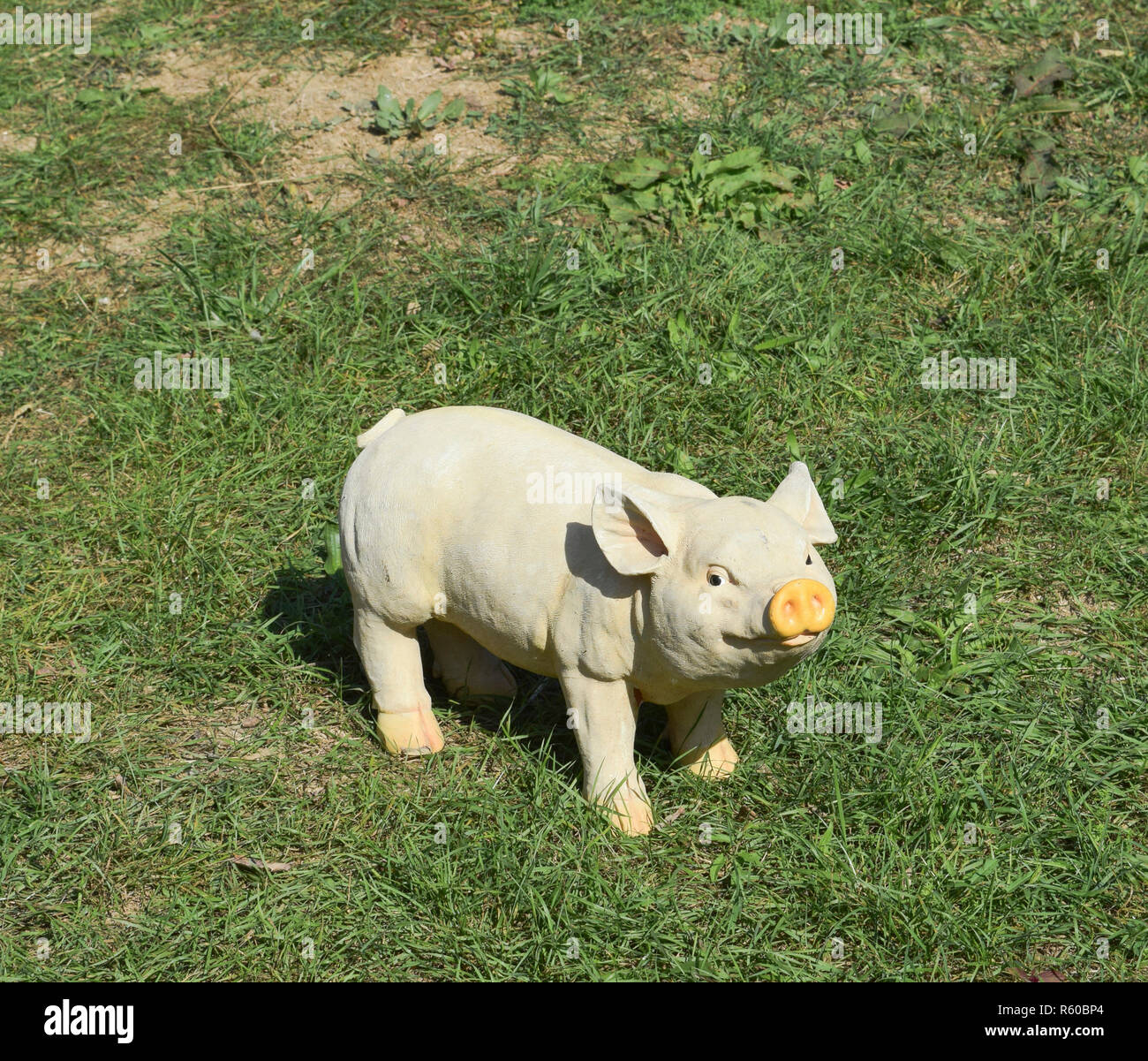 Plastic toy pig. Figures pigs on the lawn Stock Photo - Alamy