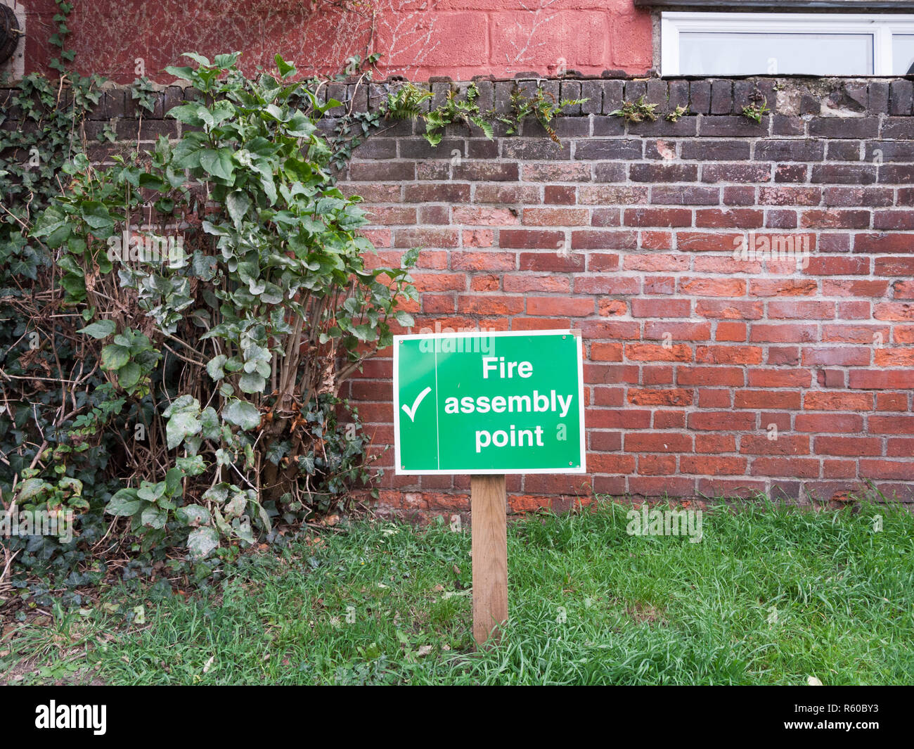 green fire assembly point wooden sign post outside safety Stock Photo ...