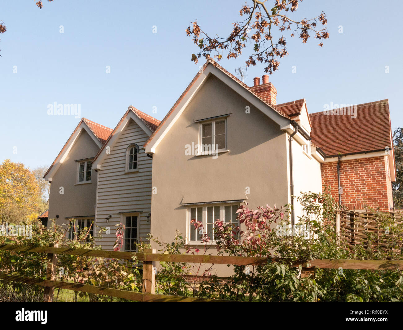 row of new modern buildings in country with fence in front Stock Photo ...