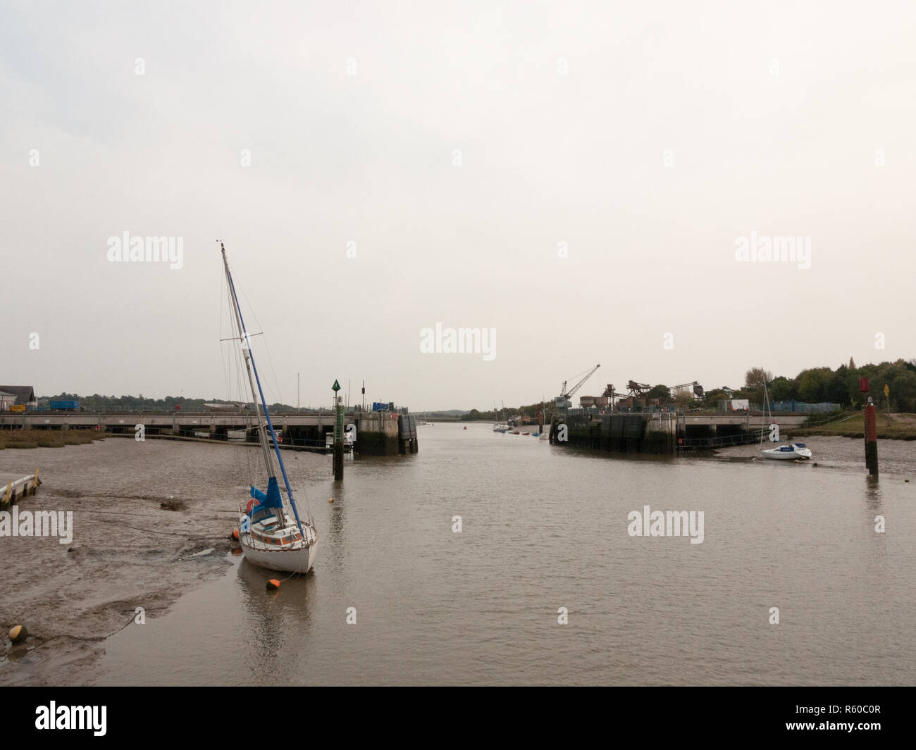 dock scene grey overcast day barrier open moored boats Stock Photo - Alamy