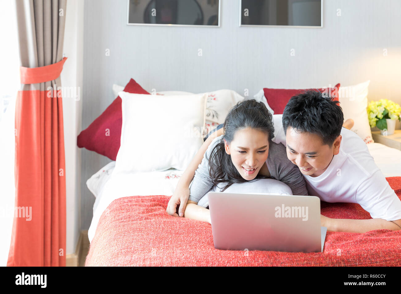 Man woman home bedroom laptop lie bed hi-res stock photography and ...