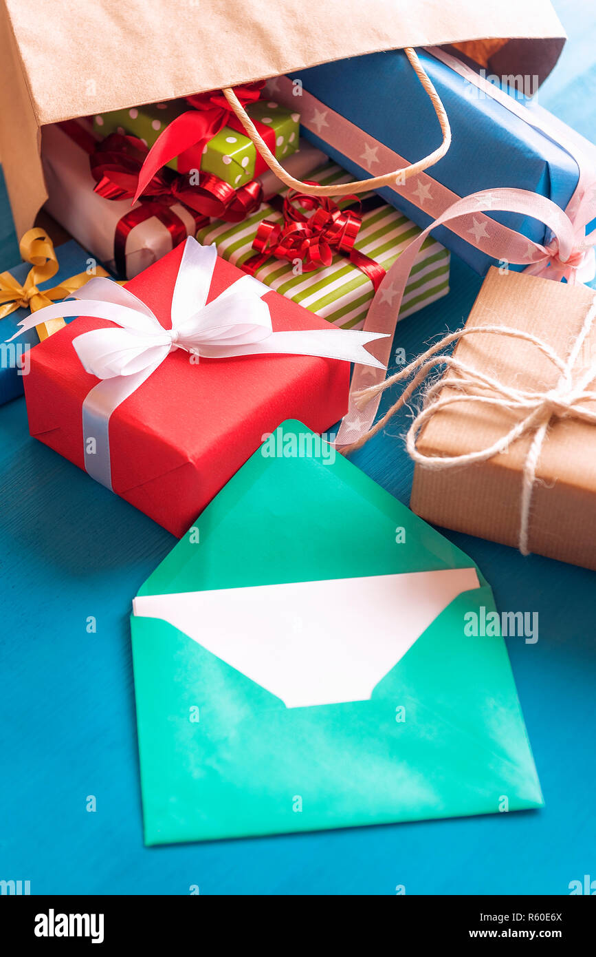 Open envelope and colorful gifts Stock Photo - Alamy