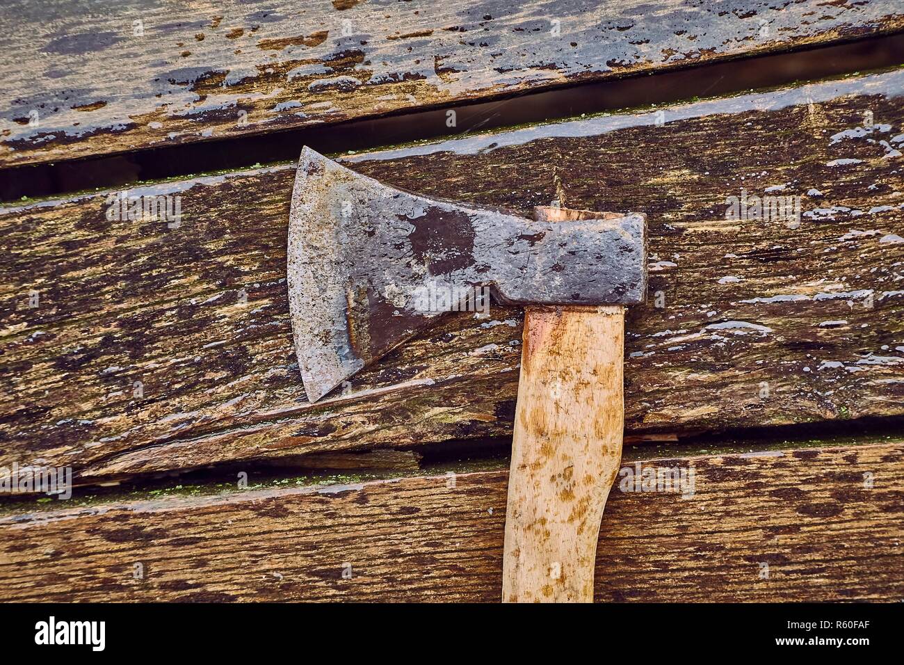 Axe on wet planks Stock Photo - Alamy