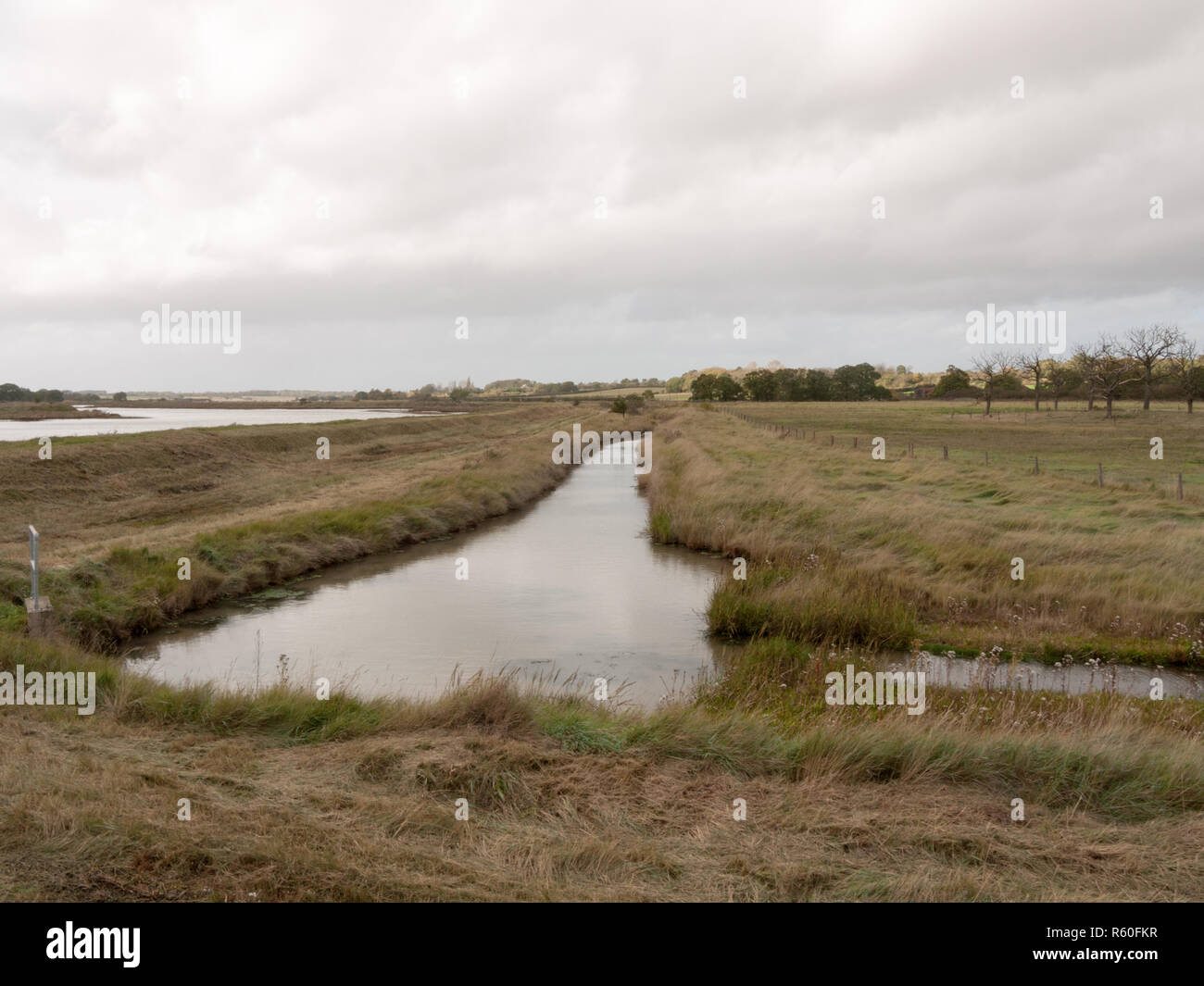 running stream through farm land grey sky Stock Photo - Alamy