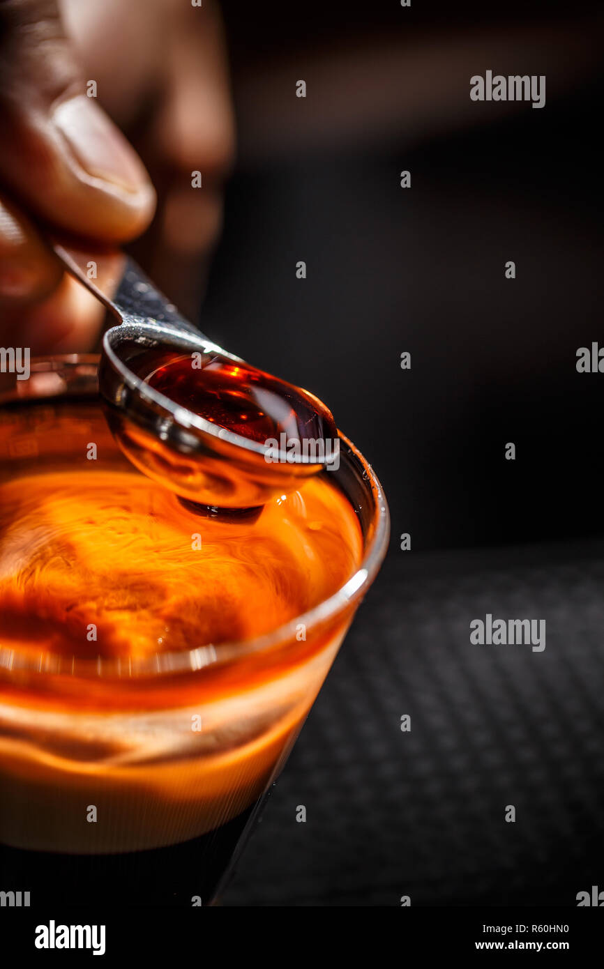 Barman hand pouring alcohol Stock Photo - Alamy