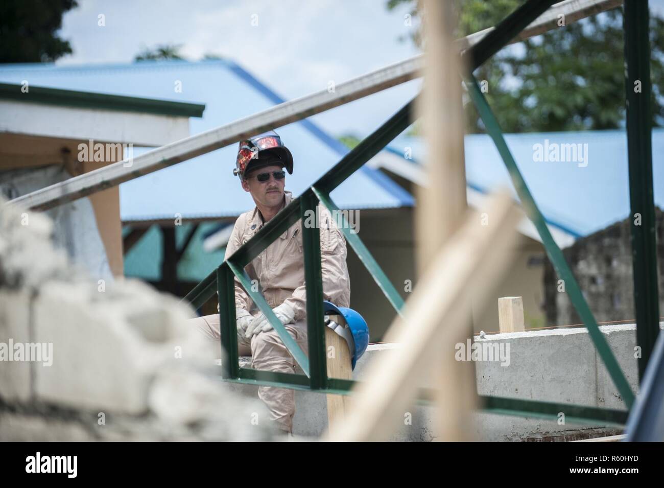 U.S. Marine Staff Sgt. Mathew Rose supervises from one of the roof ...