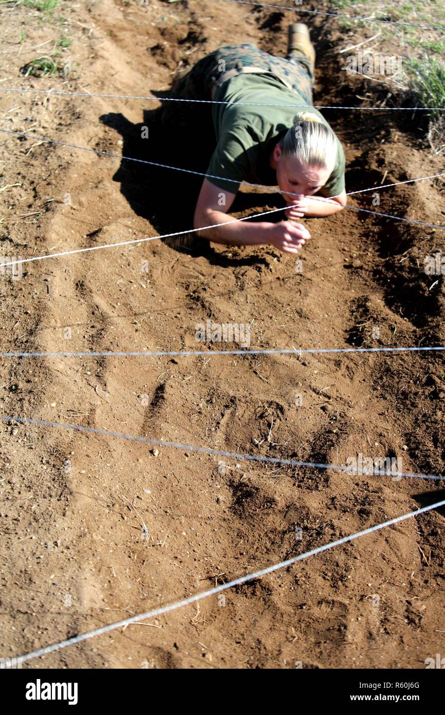 A Marine Corps officer candidate navigates an obstacle while ...