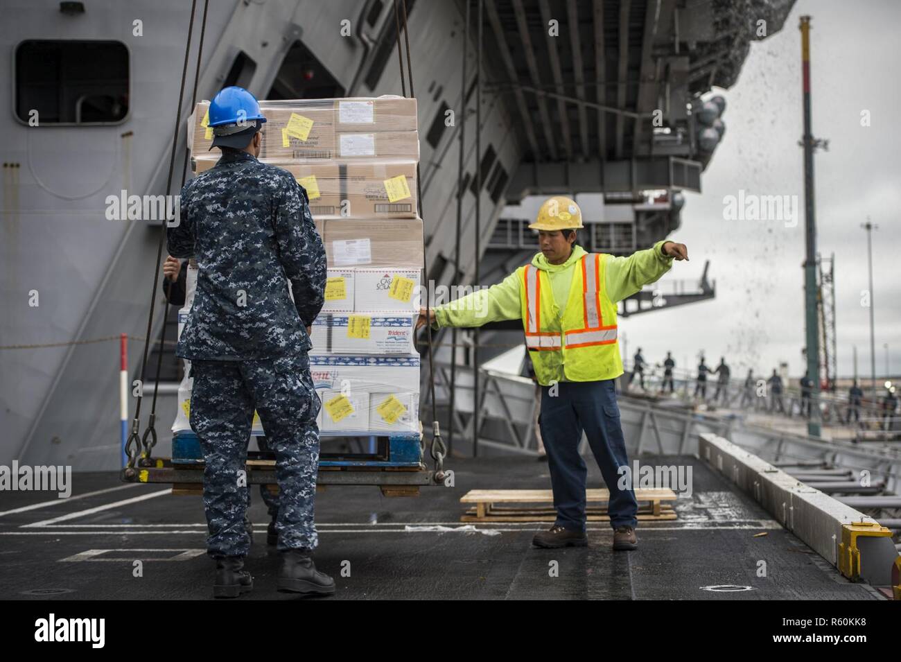 NORFOLK (April 26, 2017) Sailors and a civilians lower supplies onto an ...