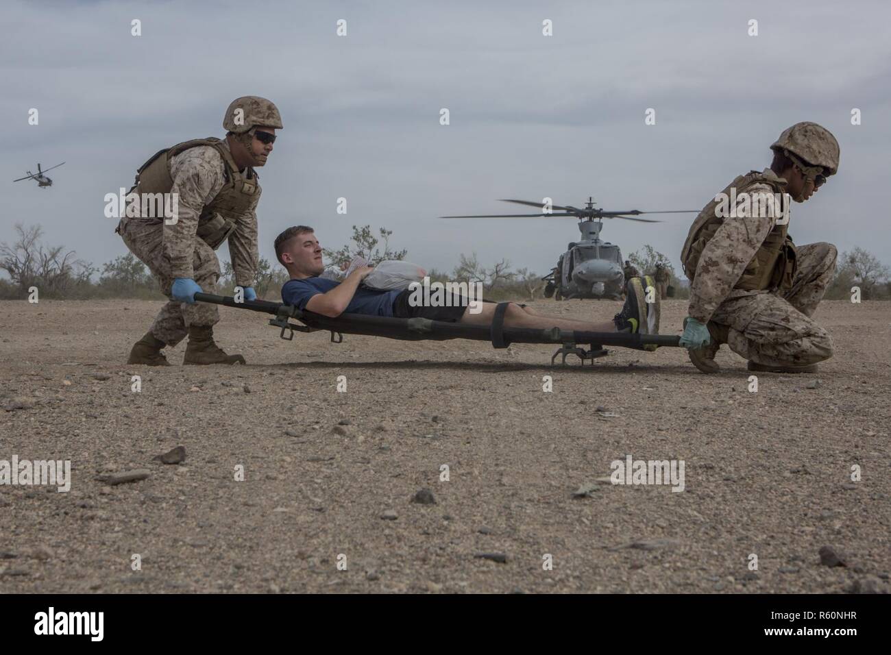 U.S. Navy Corpsmen with the 15th Marine Expeditionary Unit transport a ...