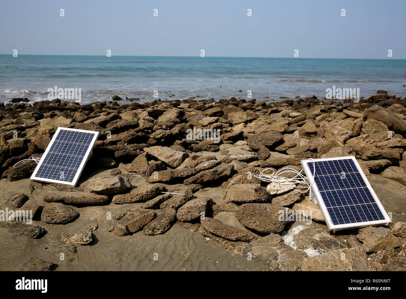 Solar panels lie under the sun on the sea beach at Saint Martin Island ...