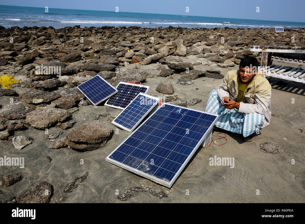 Solar panels lie under the sun on the sea beach at Saint Martin Island ...