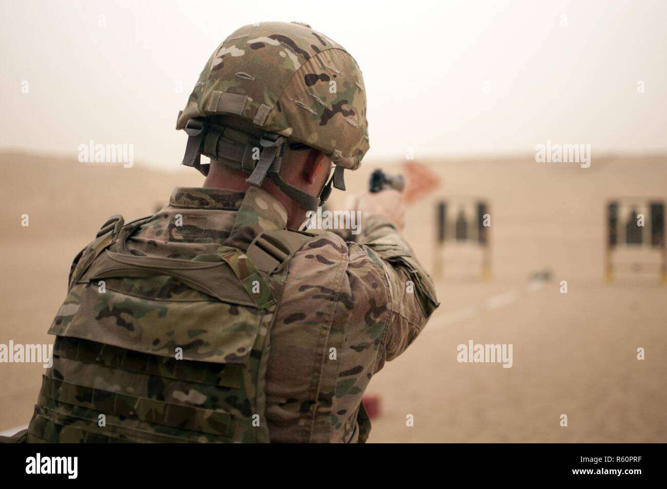 A U.S. Army Central Command Soldier fires the M9 pistol during the ...