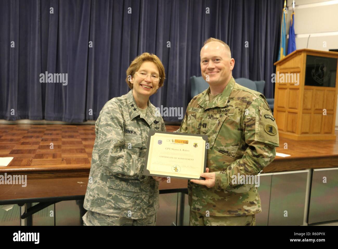 Maj. Gen. Carol Timmons presents a Certificate of Achievement to Capt ...