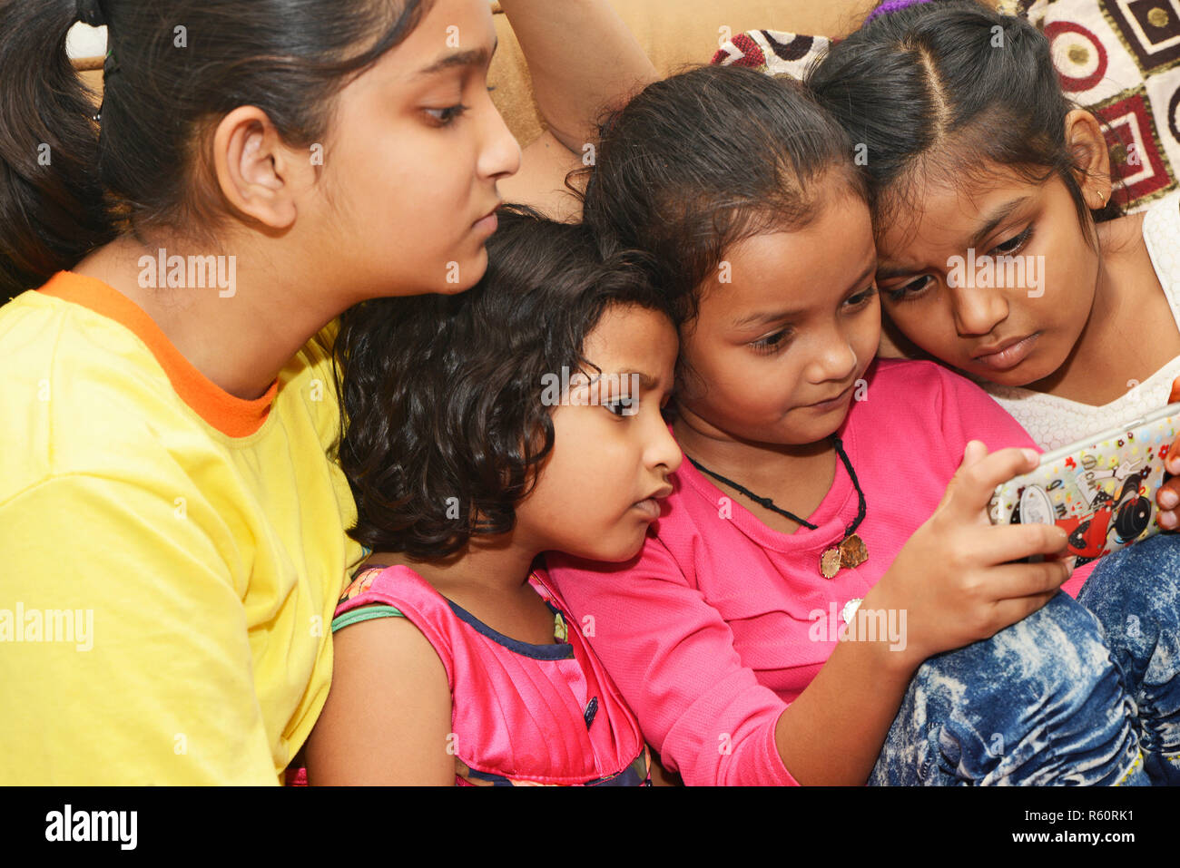 Group of children using smart phone Stock Photo - Alamy
