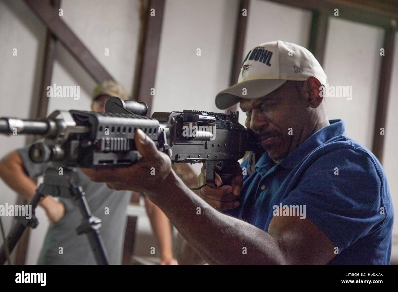 A guest holds a M240B Machine Gun at the 5th Ranger Open House 2017 on ...