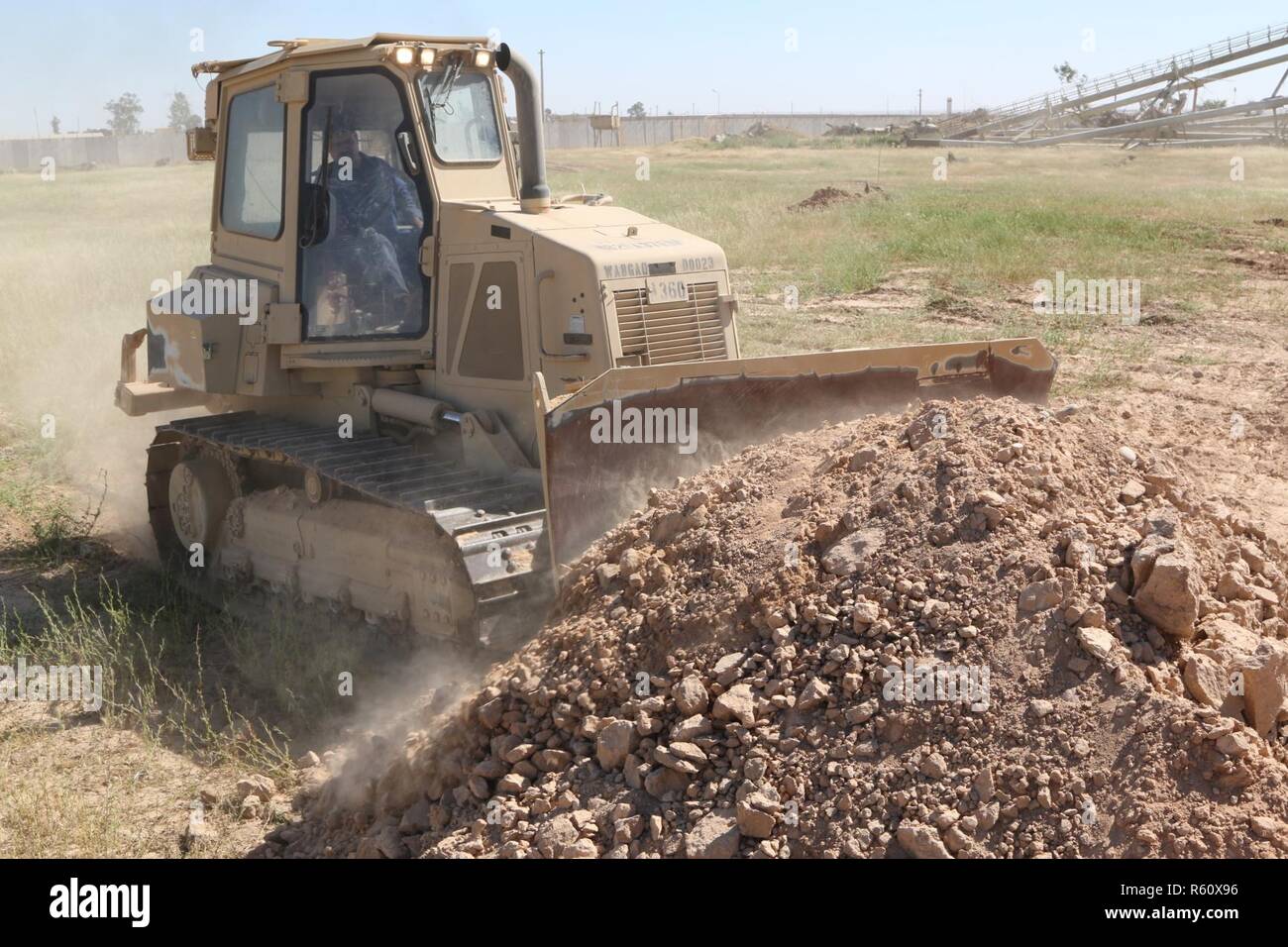 An Iraqi federal police member drives a bulldozer during a training ...