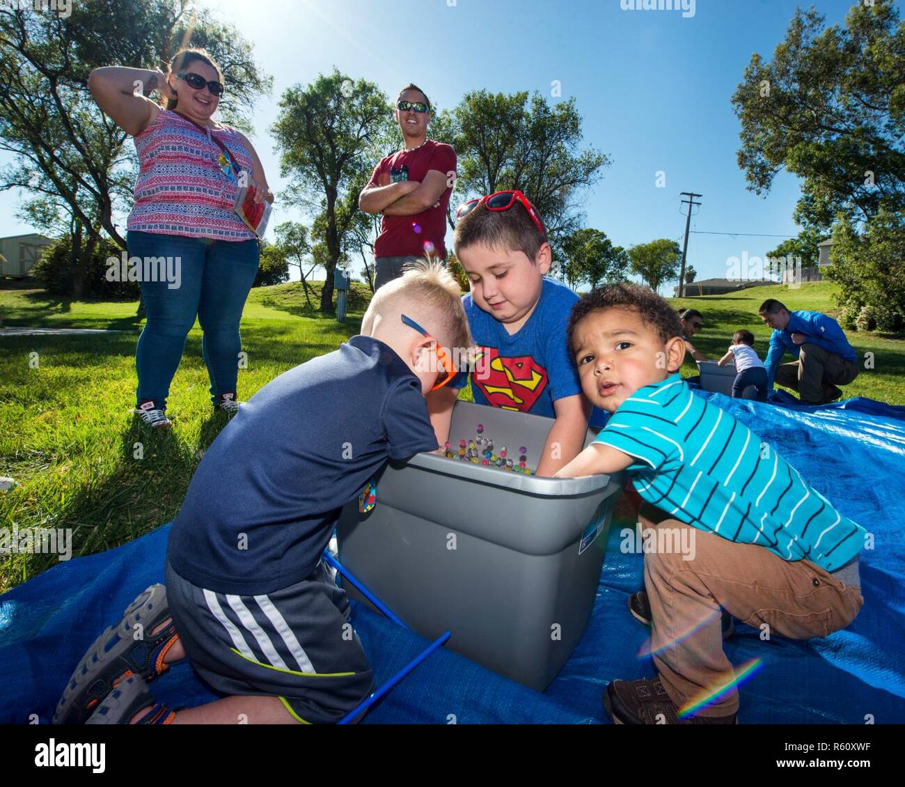 Children enjoy playing with marbles during the Autism Awareness Walk at ...