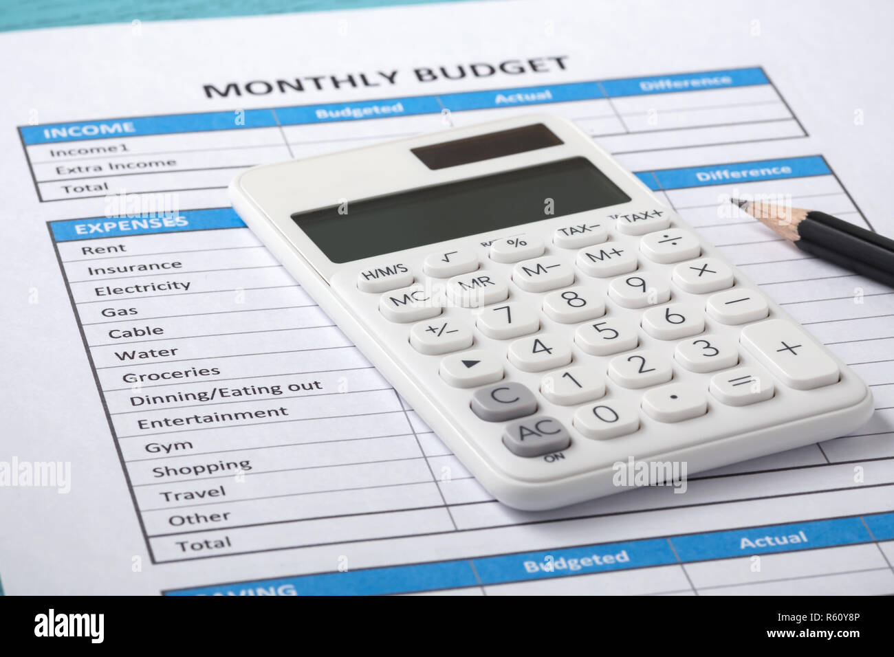 Monthly budget concept with white calculator Stock Photo - Alamy