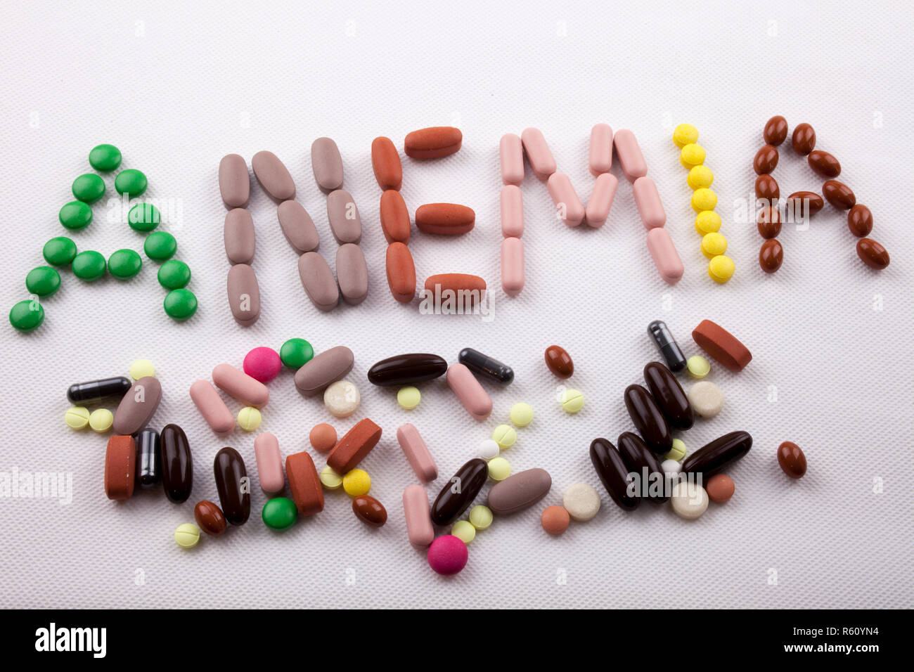 Hand writing Medical care concept written with pills drugs capsule word ...