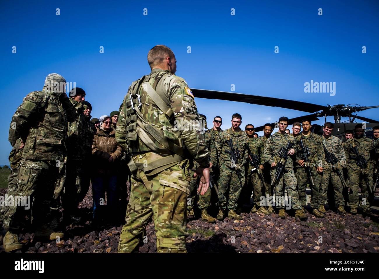 U.S. Marines and Montenegrin soldiers receive a brief before riding in ...