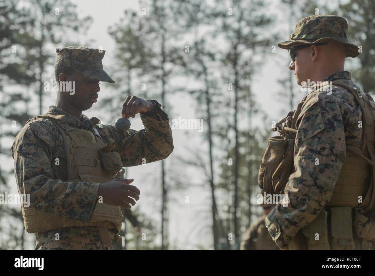 A Marine handles an M69 practice grenade during a grenade range at Fort ...
