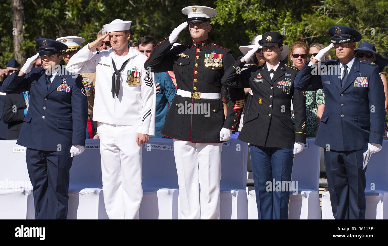 Airmen, Sailors, Marines and Soldiers salute during the presentation of ...