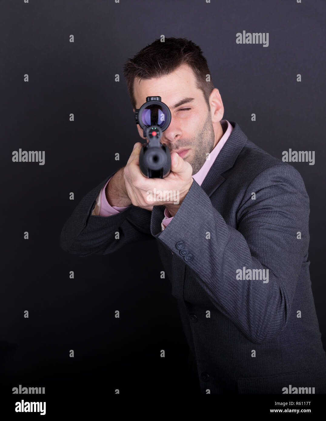 Man in suit with rifle and scope, isolated on black Stock Photo - Alamy