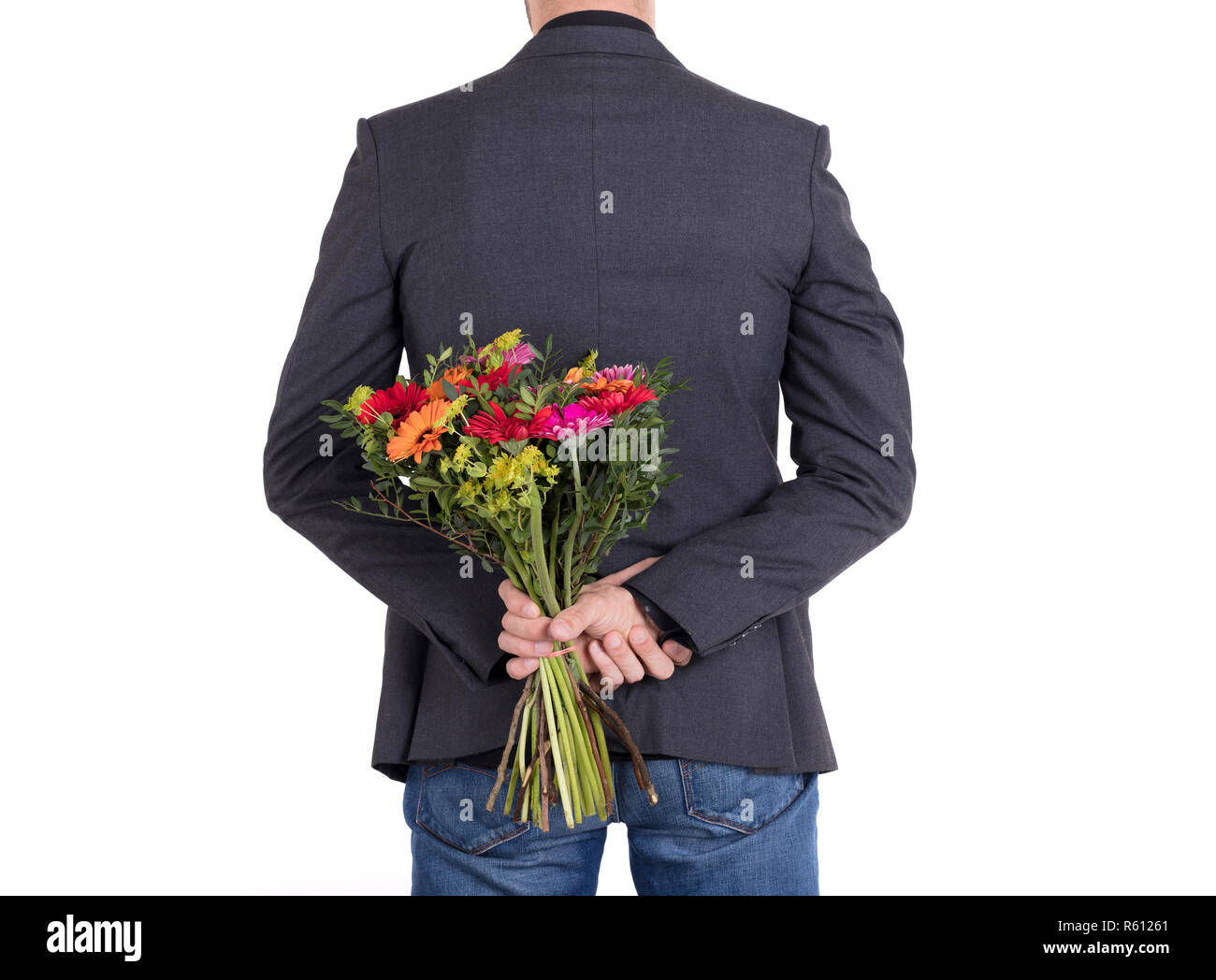 Man is hiding flowers behind his back - Isolated Stock Photo - Alamy