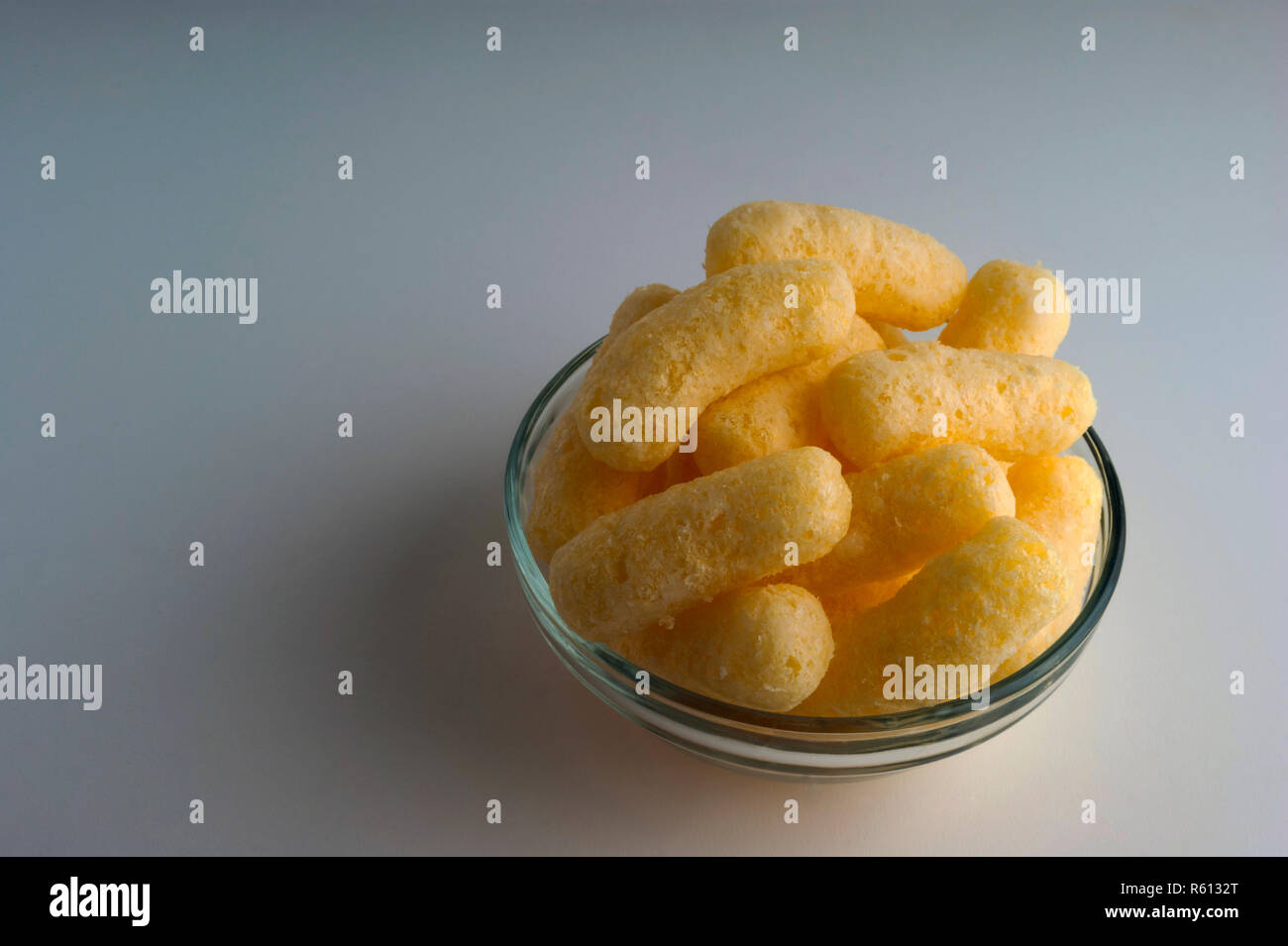 Corn Puffs in a Glass Bowl. Crunchy Flavored Puffed Snacks. Party ...