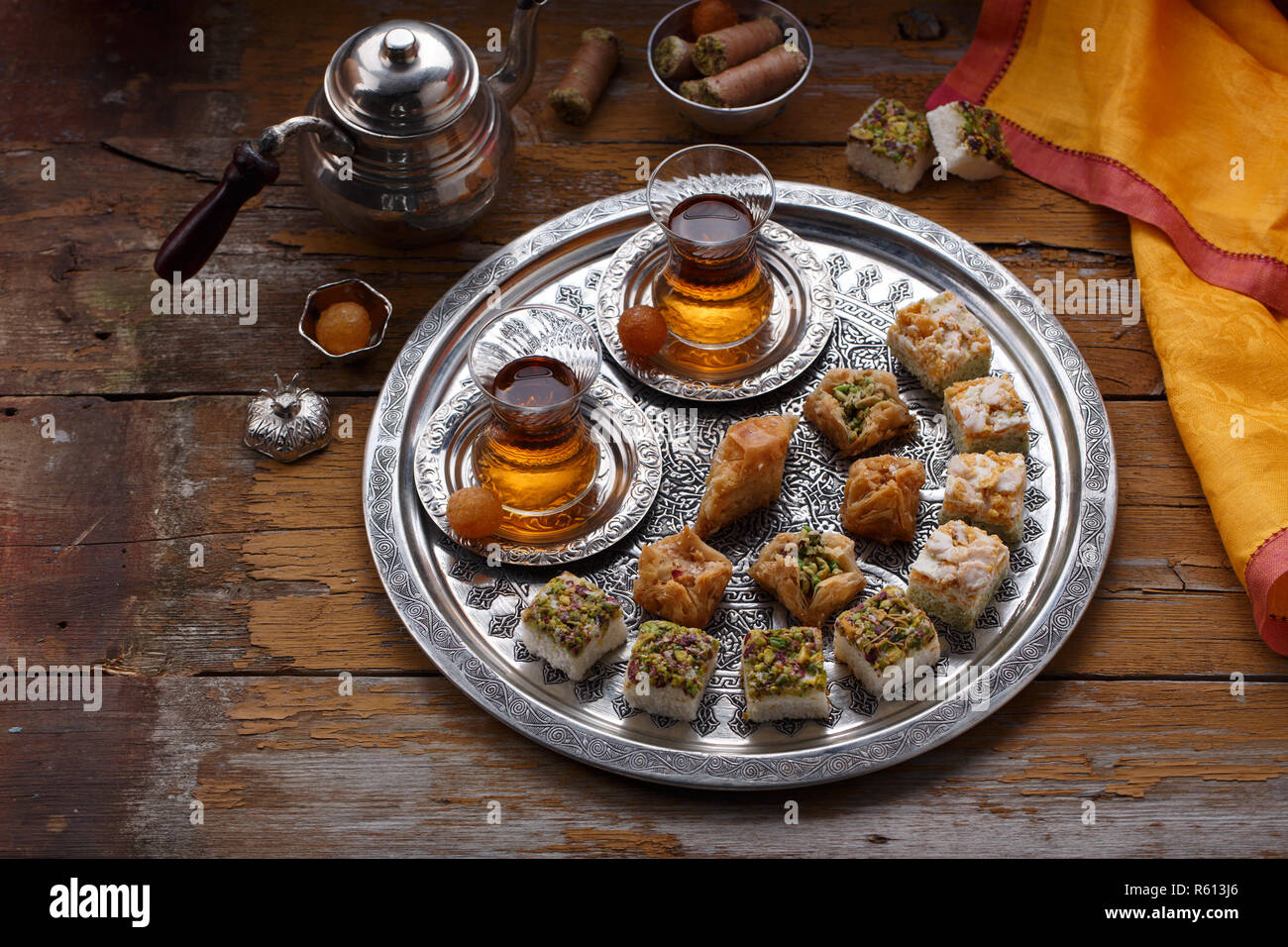 Assorted oriental sweets with tea in traditional cups, copy space Stock ...