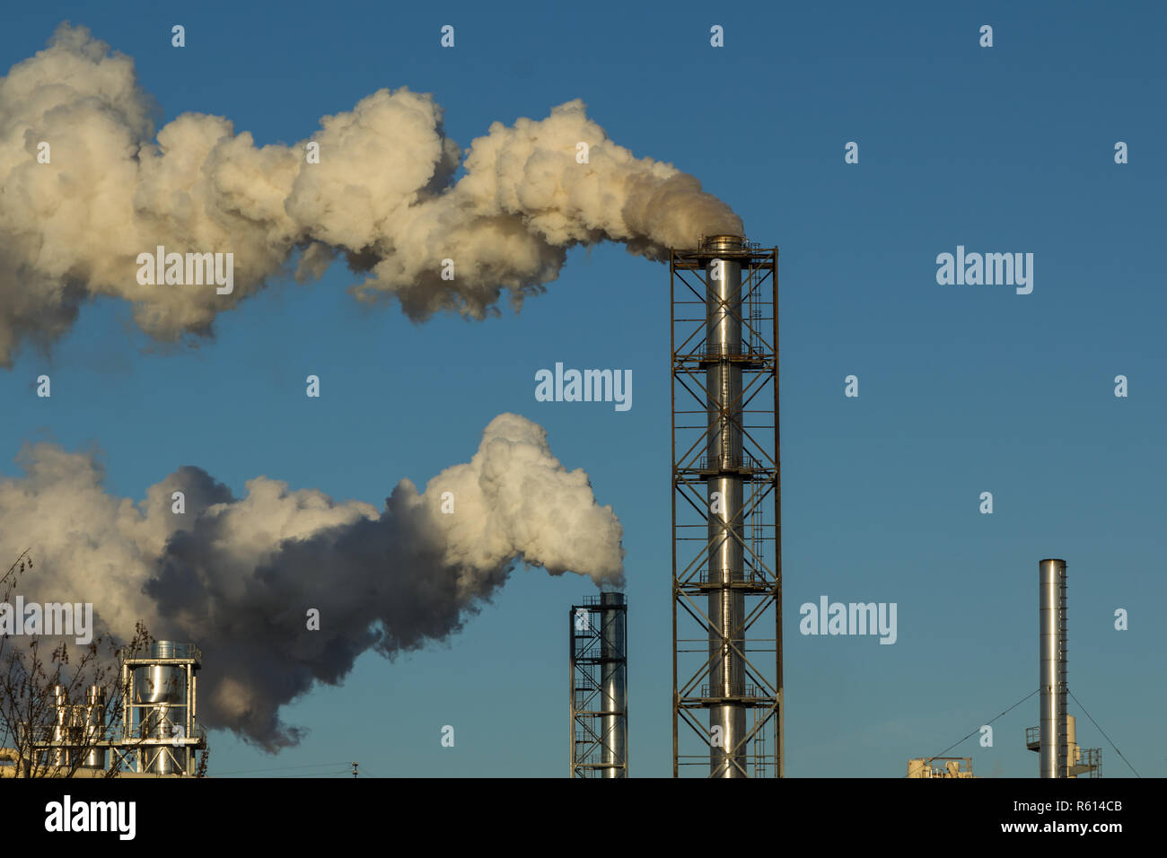 Smoking refinery chimneys hi-res stock photography and images - Alamy