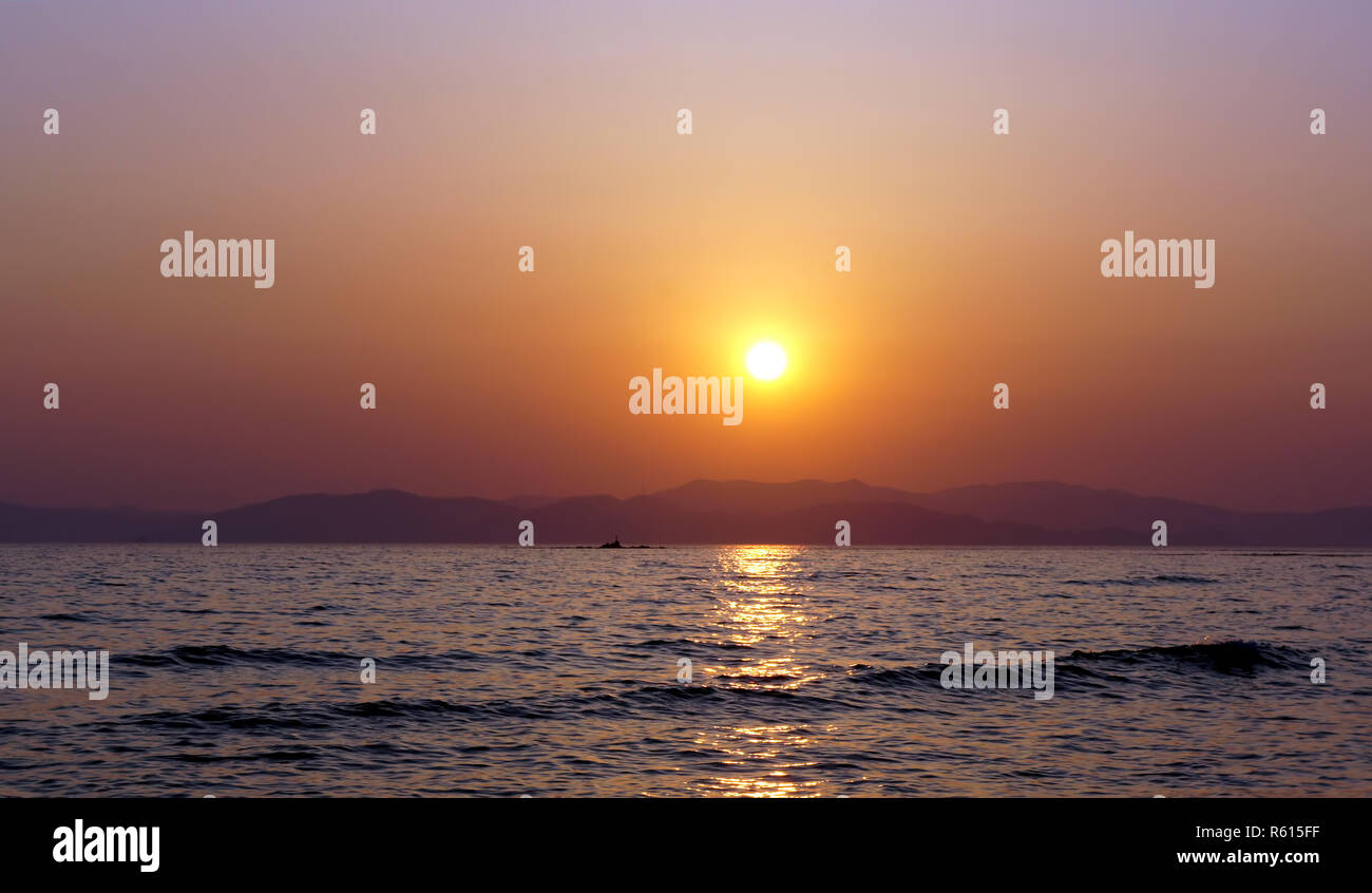 Seascape with beautiful sunset over the sea Stock Photo - Alamy