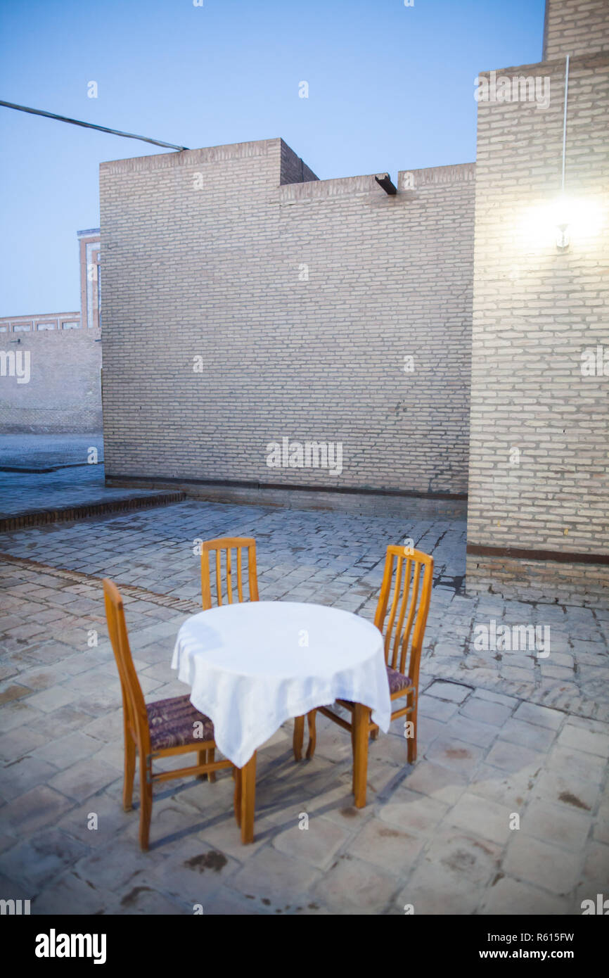 Empty dinner table on a quiet street Stock Photo - Alamy