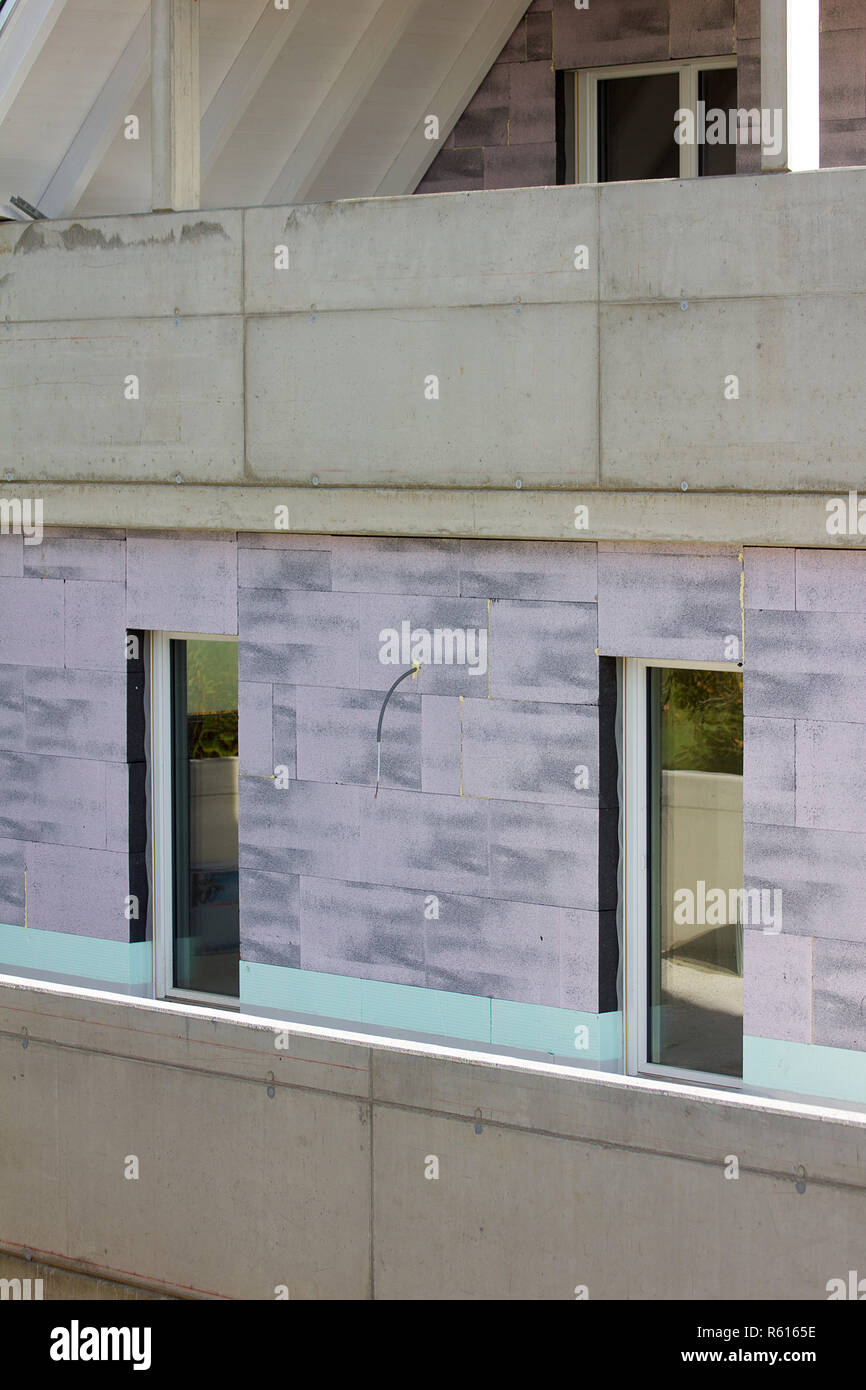 new building with two windows and thermal insulation panels added on ...