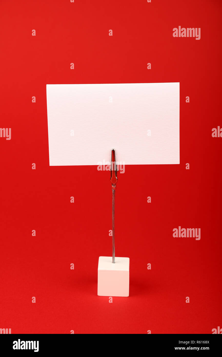 Blank white paper sign over red background Stock Photo - Alamy