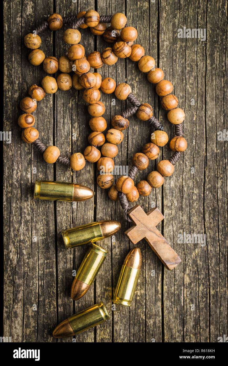 Rosary beads and pistol bullets Stock Photo - Alamy
