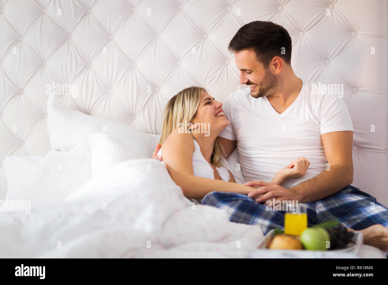 Young couple having having romantic times in bedroom Stock Photo - Alamy