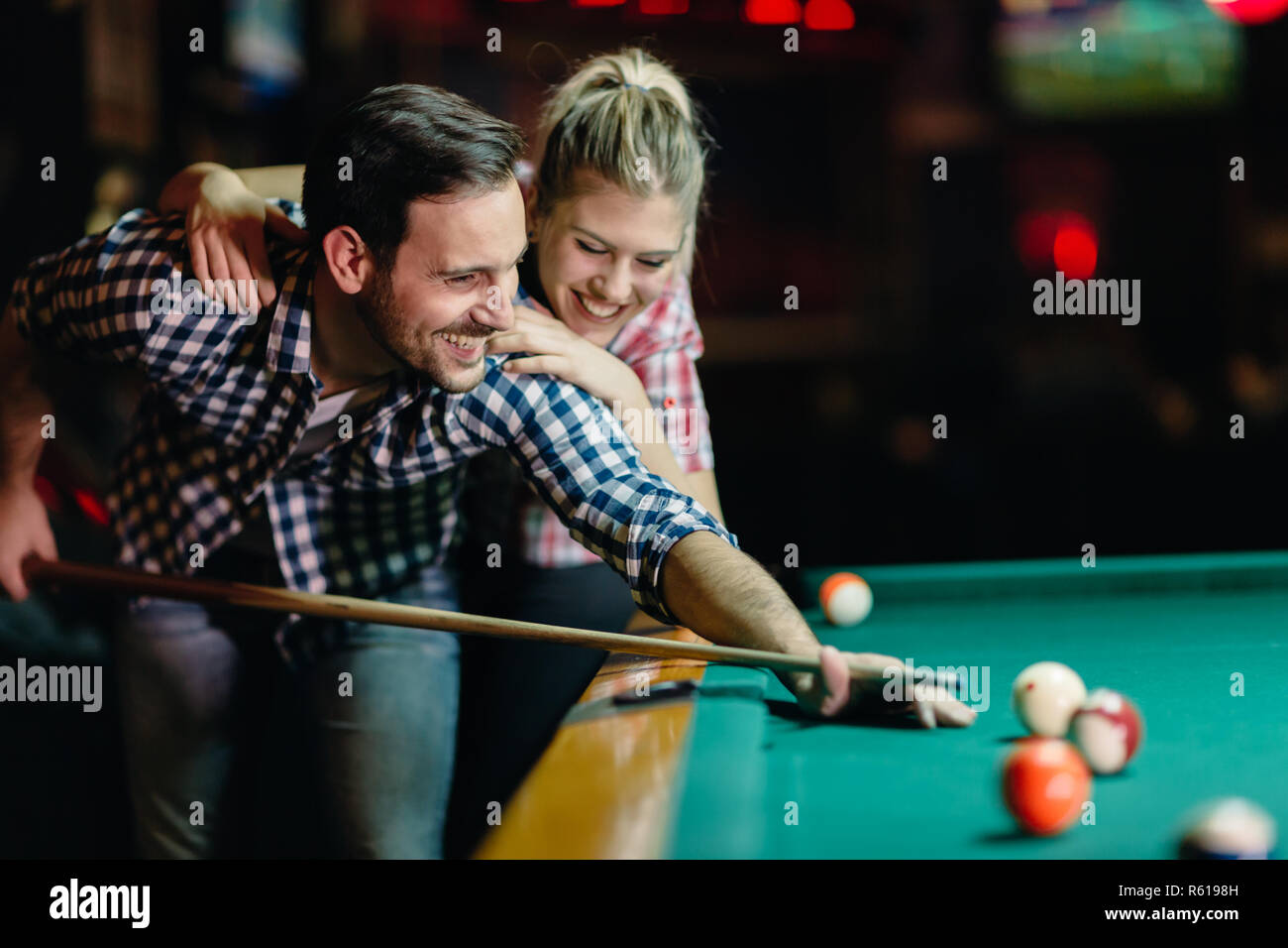 Young couple playing snooker together in bar Stock Photo - Alamy