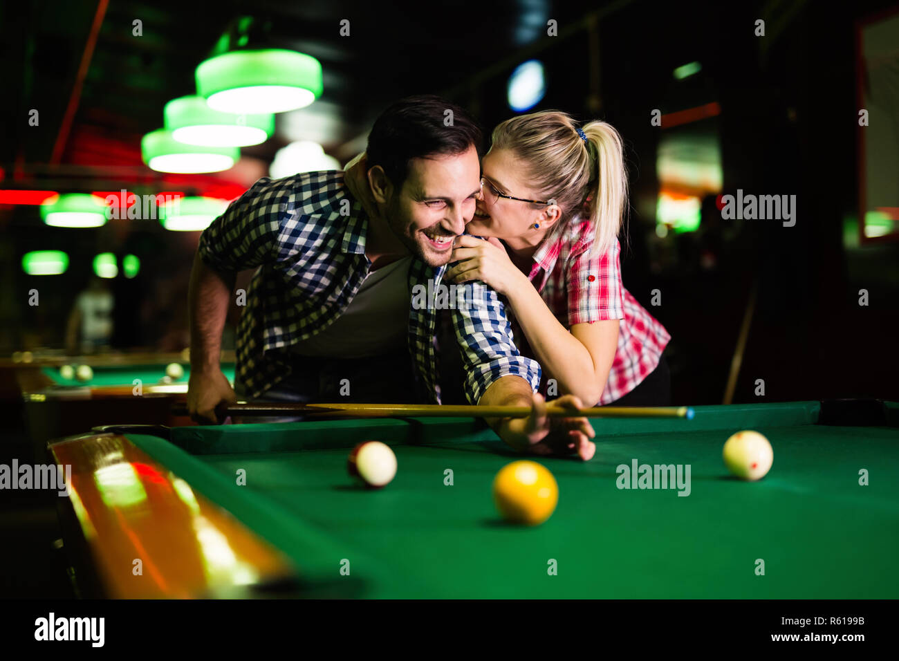 Young couple playing snooker together in bar Stock Photo - Alamy