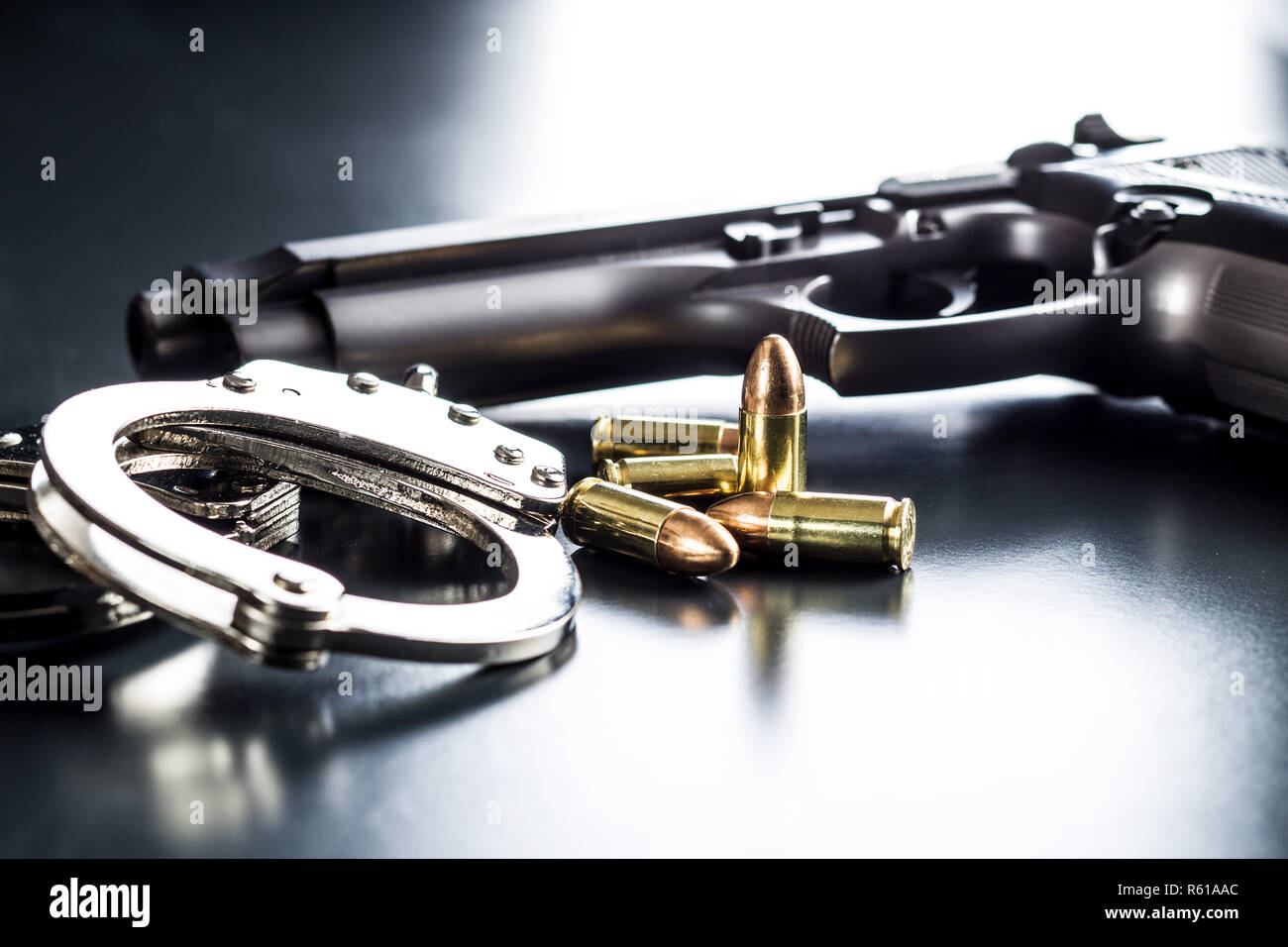 Pistol bullets, handgun and handcuffs Stock Photo - Alamy