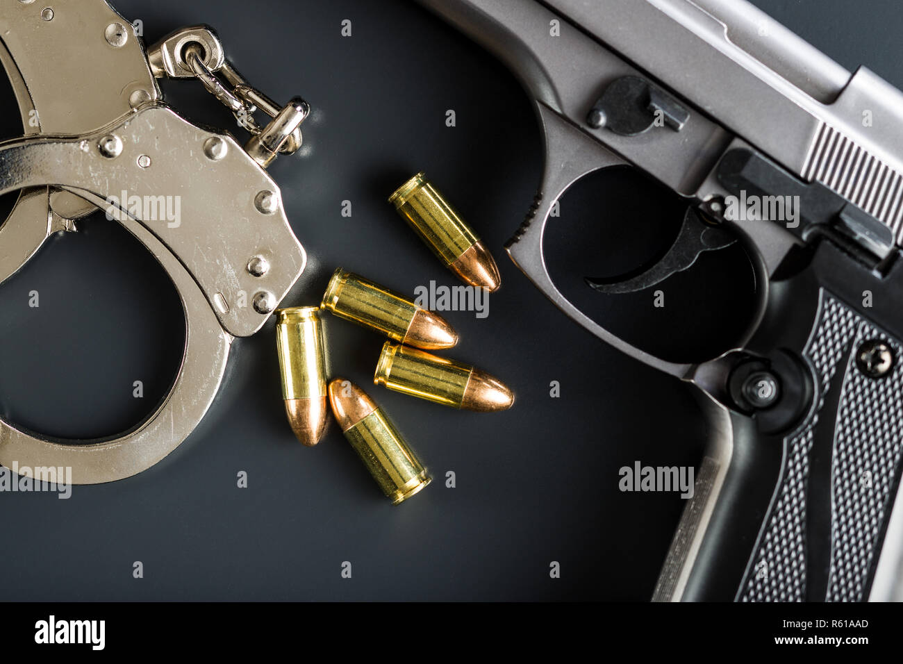Pistol bullets, handgun and handcuffs Stock Photo - Alamy