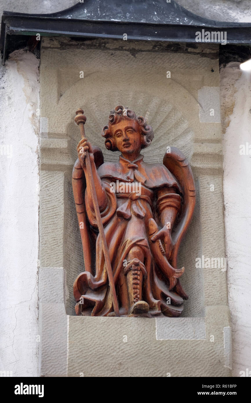 Archangel Raphael statue on the building facade in Lucerne, Switzerland ...