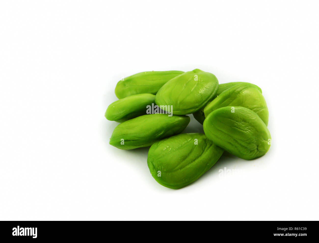 parkia speciosa isolated / close up of fresh green parkia speciosa seeds pile isolated in white ...