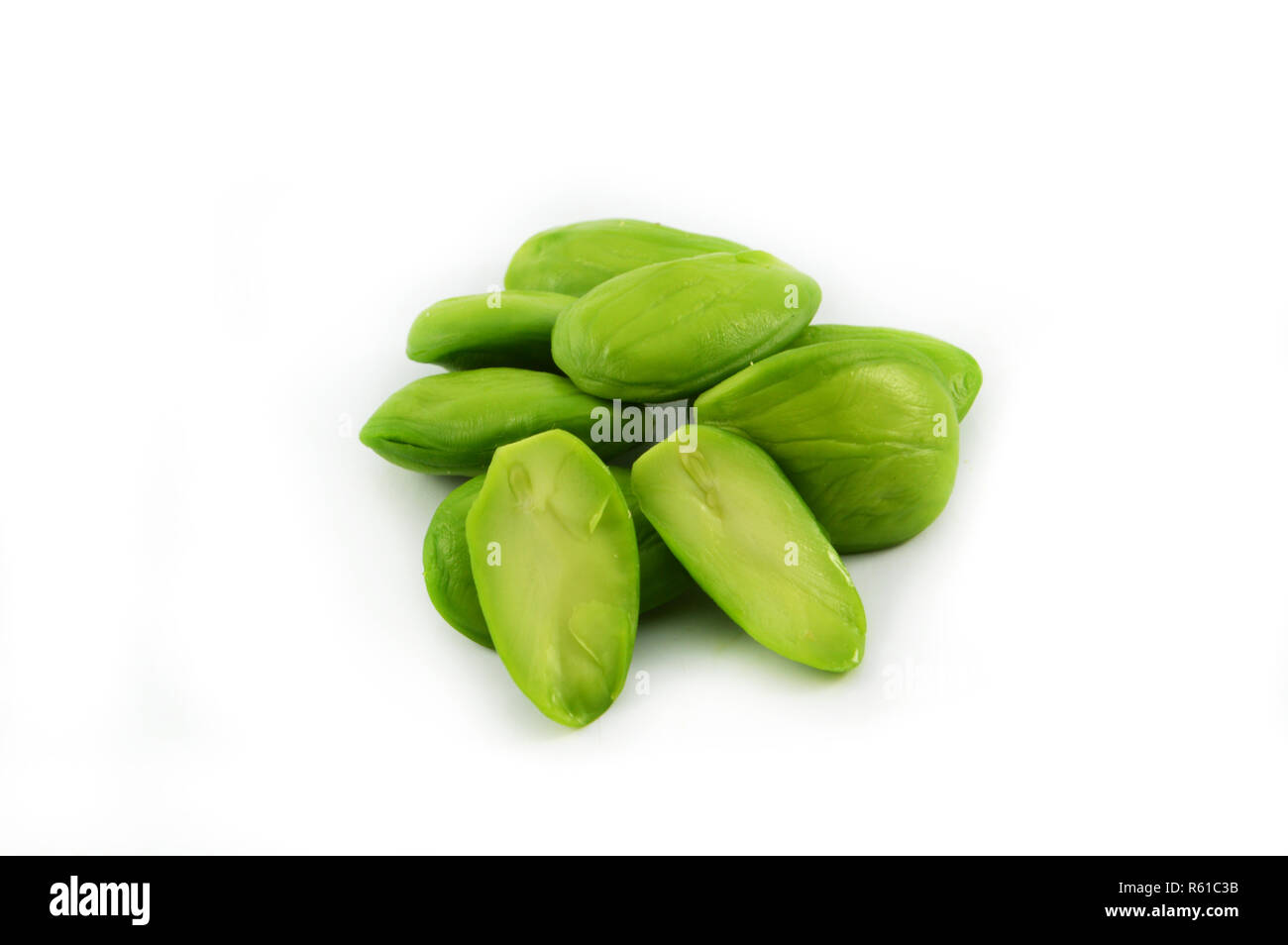 parkia speciosa isolated / close up of fresh green parkia speciosa seeds pile isolated in white ...