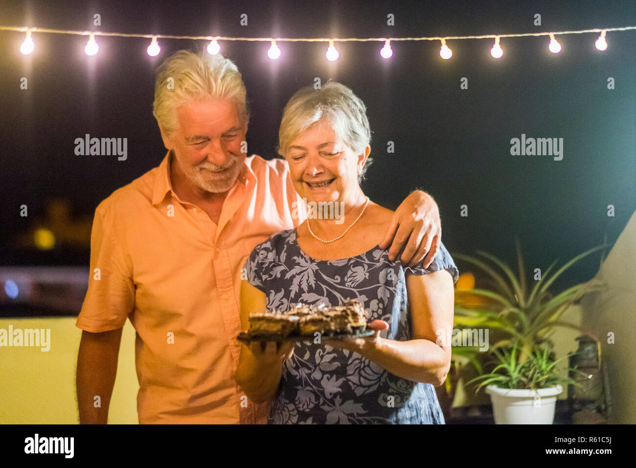 nice beautiful caucasian senior couple hug and enjoy together the night ...