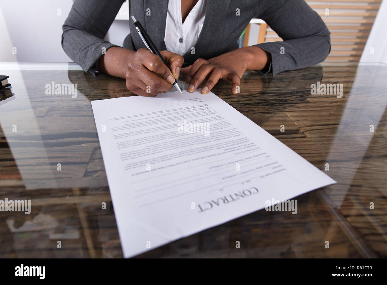 Businesswoman Holding Pen To Sign On Contract Paper Stock Photo - Alamy