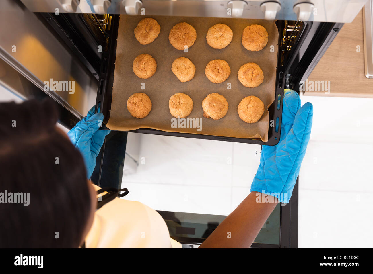 Human Hand Taking Out Tray Of Baked Cookies From Oven Stock Photo - Alamy