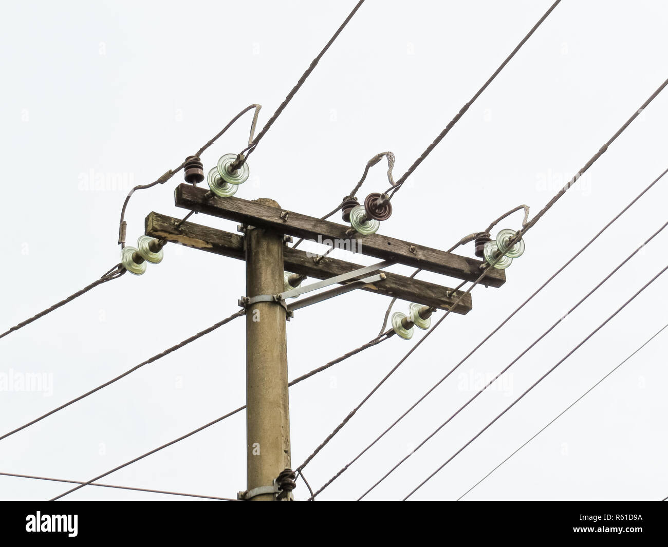 Post with electric transmission wires on white background Stock Photo ...