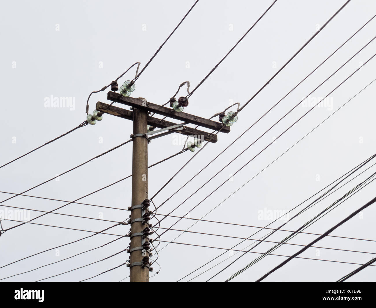 Post with electric transmission wires on white background Stock Photo ...
