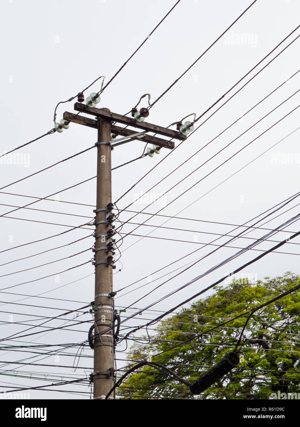 Post with electric transmission wires on white background Stock Photo ...